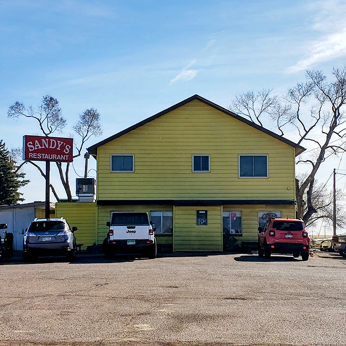 The bright yellow exterior of Sandy's stands out like a cheerful beacon, promising comfort food that doesn't need fancy architecture to impress.