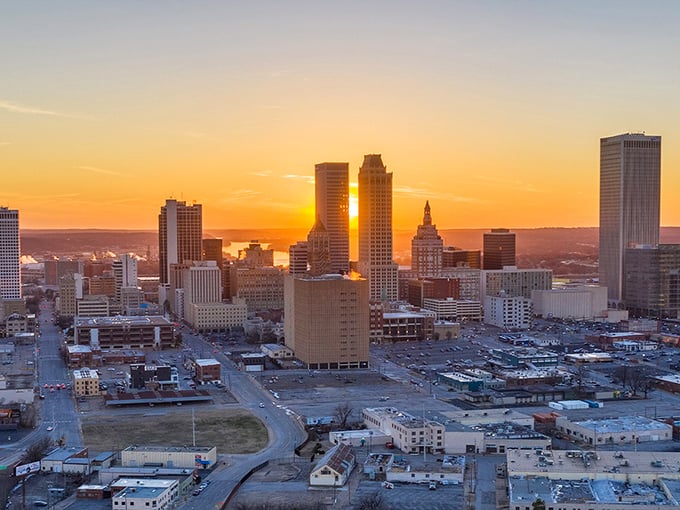 Tulsa&rsquo;s skyline glows warmly at sunset, stretching across the horizon like a modest Midwest Manhattan, showing that big city energy comes in Oklahoma-sized packages too.