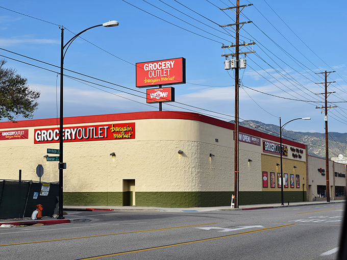 Grocery Outlet's iconic red signage promises bargain hunting adventures against California's mountain backdrop – where savings meet sunshine.