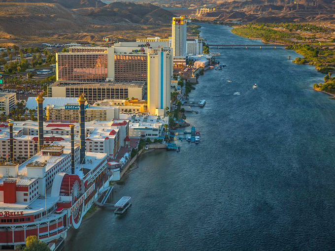 Laughlin's riverside resorts catch the golden hour light, their reflections dancing on the Colorado River like nature's own light show.