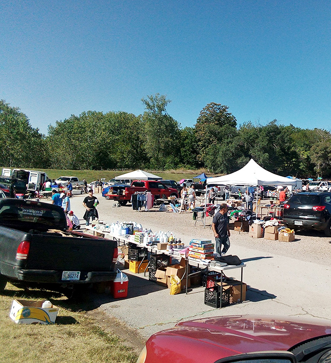 Where treasure hunting meets social club! The gravel lot transforms into a bargain hunter's paradise every weekend, with pop-up tents stretching toward the tree line.