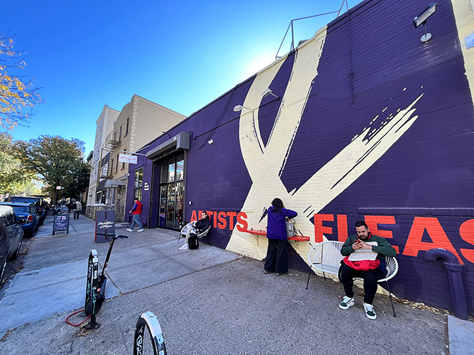 The purple facade of Artists & Fleas stands like a creative beacon in Williamsburg, inviting treasure hunters and the perpetually curious to step inside and discover their next conversation piece.