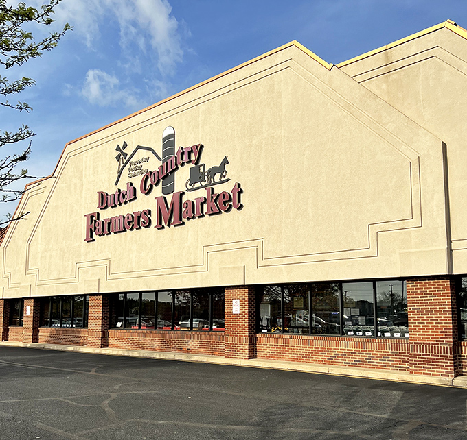 The iconic facade of Dutch Country Farmers Market stands proudly against the Delaware sky, promising treasures that no online shopping cart could ever deliver.