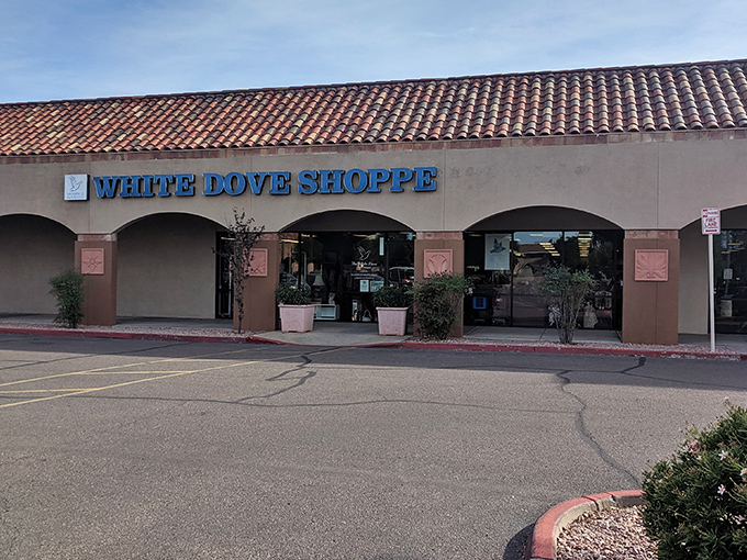 The White Dove Thrift Shoppe welcomes bargain hunters with its distinctive blue signage and Spanish-style roof&mdash;thrifting paradise awaits!