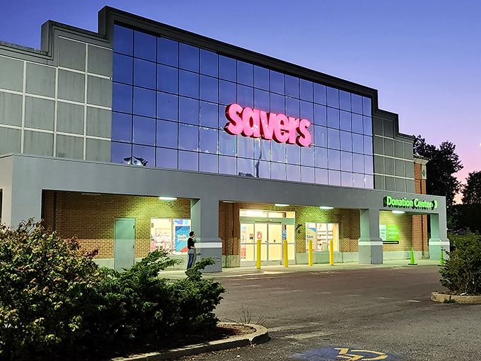 The iconic red Savers sign glows like a beacon at dusk, promising treasure hunters the thrill of the unexpected inside.