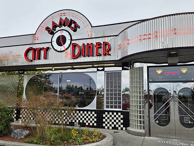Neon glows like a beacon against the Alaskan sky, promising comfort food salvation with that iconic red signage that practically screams "milkshakes and memories inside!"