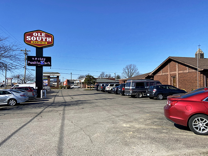 A roadside Ole South Bar-B-Q sign towers over a full parking lot, promising classic Kentucky barbecue worth the stop.