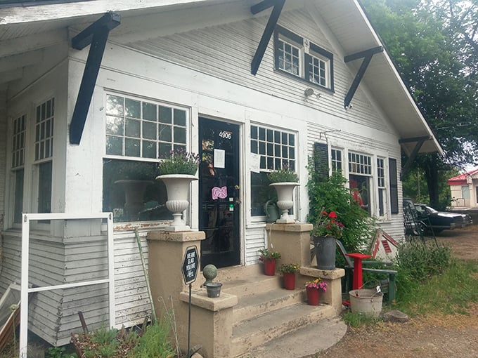 The charming cottage exterior of Enchanting Objects welcomes treasure hunters with stone planters and greenery framing its inviting entrance.