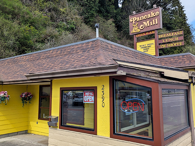 The cheerful yellow exterior of Pancake Mill stands like a breakfast lighthouse on the Oregon coast, beckoning hungry travelers with promises of pancake perfection.
