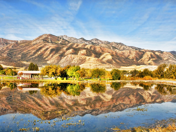 The Wellsville Mountains create nature's perfect mirror image across still waters, proving Utah doesn't need Photoshop to look this good.