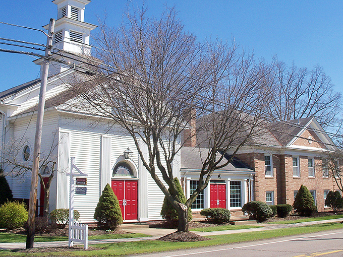 The historic white church with its striking red doors stands as Bolivar's spiritual anchor, a timeless landmark where generations have gathered since horse-and-buggy days.