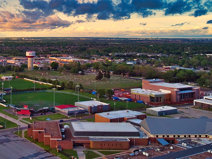 Sunset paints Mustang's skyline in Oklahoma gold, with the iconic water tower standing sentinel over this charming suburban escape just minutes from OKC's hustle.