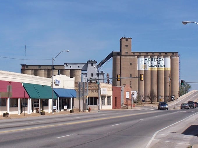 Downtown Chickasha showcases its agricultural roots with the imposing Livestock Nutrition Center silos standing sentinel over charming storefronts &ndash; small-town America at its most authentic.