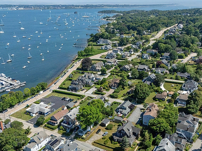 Aerial paradise! Jamestown's coastline unfolds like nature's perfect postcard, where sailboats dot the blue waters and charming homes nestle among lush greenery.