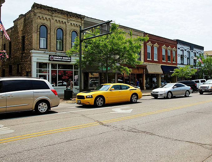 Historic brick buildings line Lake Geneva's Main Street, where small-town charm meets upscale boutique shopping. That yellow Charger isn't subtle, but neither is Wisconsin's hospitality.