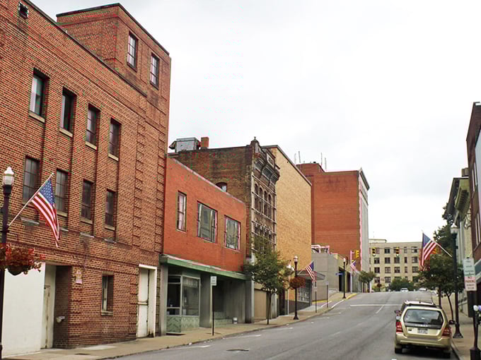 Brick facades tell stories without saying a word on Bluefield's historic main street, where American flags wave proudly against the mountain town's architectural timeline.
