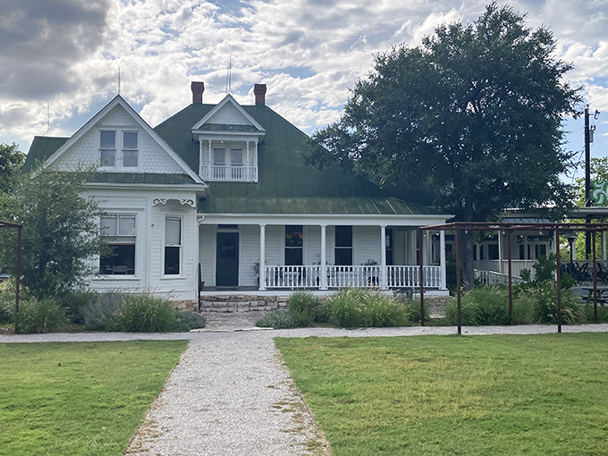 The Victorian facade of Hooper's stands like a welcoming haunted house, complete with wraparound porch and green roof that practically whispers, "Come in... if you dare."