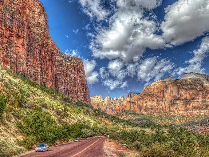 Nature's own IMAX theater unfolds with every mile. The crimson cliffs and azure sky create a color palette that would make Monet jealous.