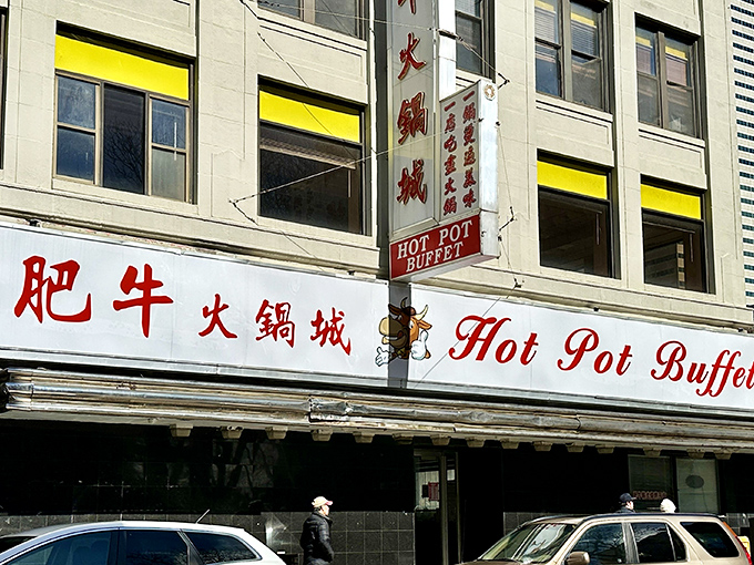 The bright red signage of Hot Pot Buffet stands as a beacon in Boston's Chinatown, promising culinary adventures that transcend language barriers.
