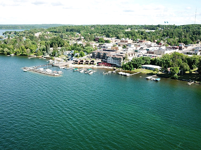 An aerial view of Walker nestled against Leech Lake's sparkling shoreline, where pristine waters meet the town's quaint downtown area.
