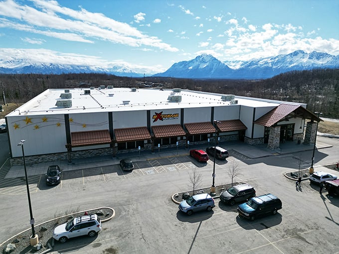 The ultimate Alaskan contradiction: pristine mountain views framing an indoor playground where speed demons and arcade warriors unite under one roof.