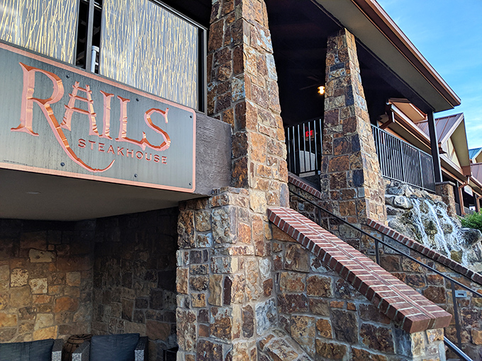 The stone fortress of flavor beckons with its copper-hued sign, promising carnivorous delights that would make even the most committed vegetarian reconsider their life choices.