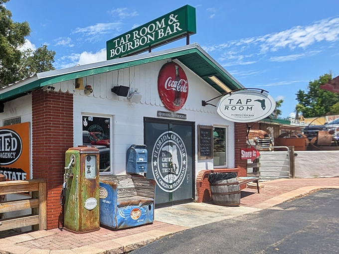 The iconic exterior of Florida Cracker Kitchen beckons with rustic charm and that unmistakable "In Grits We Trust" promise. Old gas pumps and weathered barrels complete the time-traveling experience.
