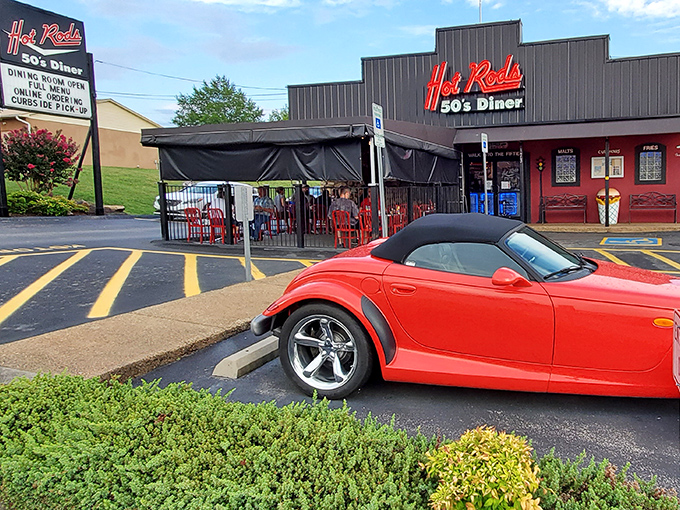 The neon sign beckons like a lighthouse for hungry travelers. Hot Rods 50's Diner stands proud against the Tennessee sky, with classic cars often parked outside.