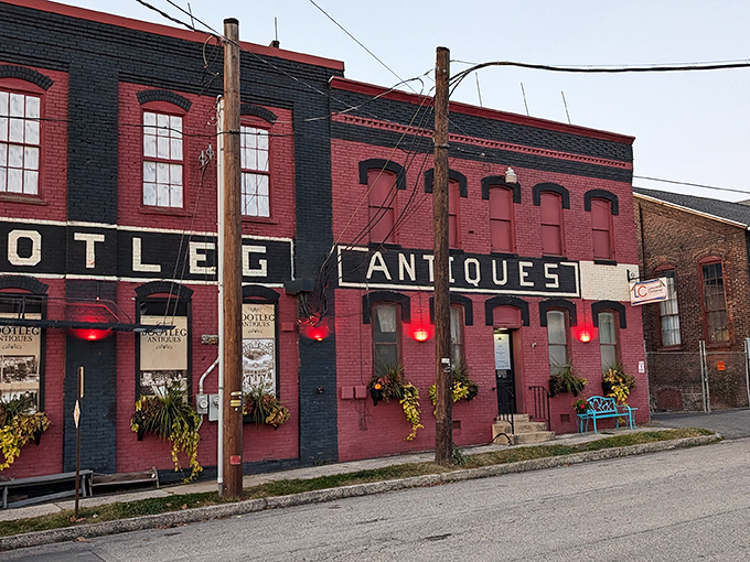 The brick-red facade of Bootleg Antiques isn't just eye-catching&mdash;it's practically a time portal disguised as architecture, complete with vintage-style lighting that glows like memories.
