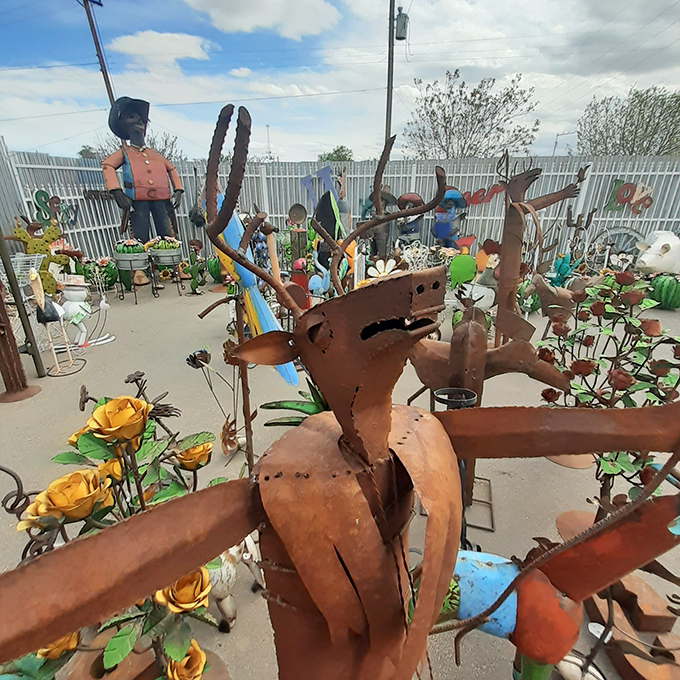 A whimsical garden of metal sculptures where rusty dinosaurs and colorful flowers coexist like the fever dream of an artistic welder with a green thumb.