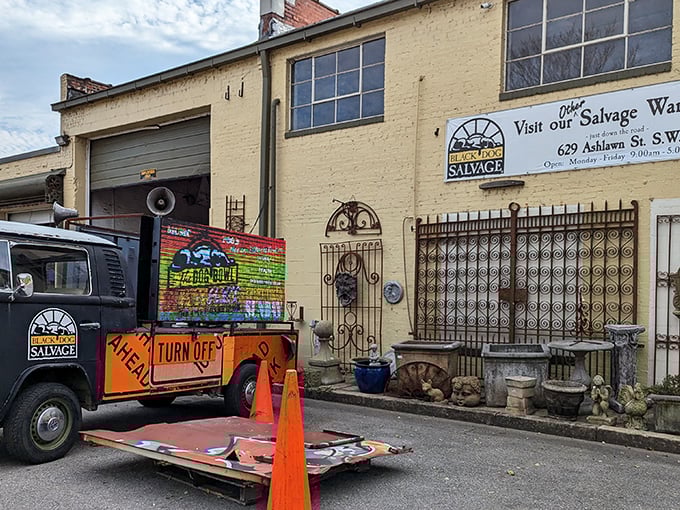 The exterior of Black Dog Salvage's warehouse, showcasing vintage architectural elements and their signature salvage truck.