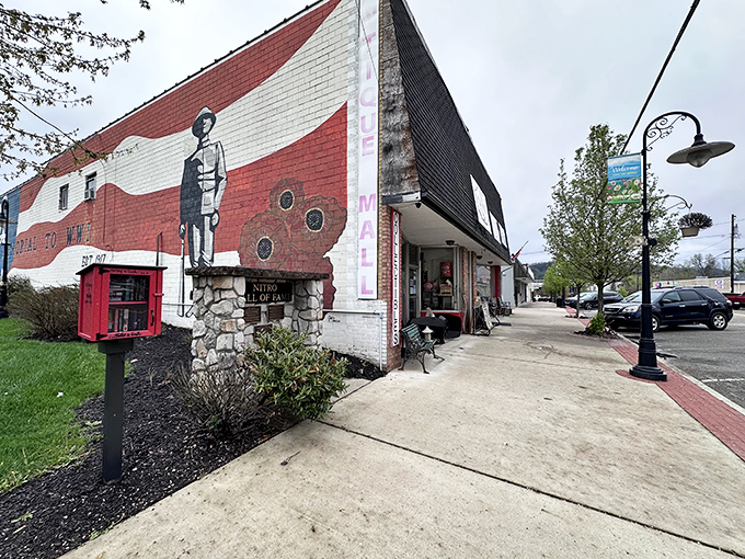 The distinctive red and white exterior of Nitro Antique Mall beckons treasure hunters with its eye-catching mural and stone accents&mdash;architectural character that hints at the wonders within.