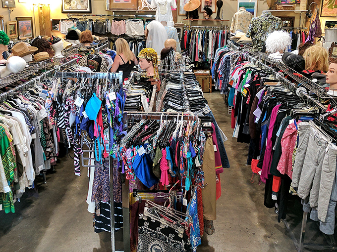 Treasure hunters navigate the colorful clothing canyons of Village Merchants, where vintage fashion dreams come true and wallets breathe sighs of relief.