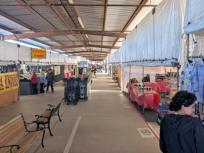 The main thoroughfare at Arizona Market Place stretches like a treasure map waiting to be explored, with vendors lining both sides of the covered walkway.
