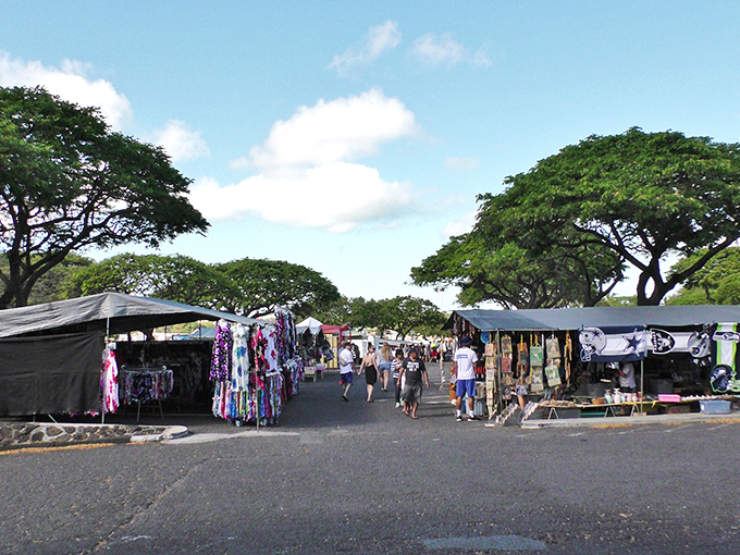 Beneath the watchful shade of monkeypod trees, shoppers hunt for treasures along aisles that feel more like tropical village streets than a parking lot.