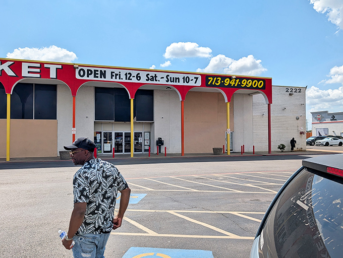 The vibrant red and yellow arches of Pasadena Indoor Flea Market stand like a carnival of commerce, beckoning bargain hunters with promises of treasures within.