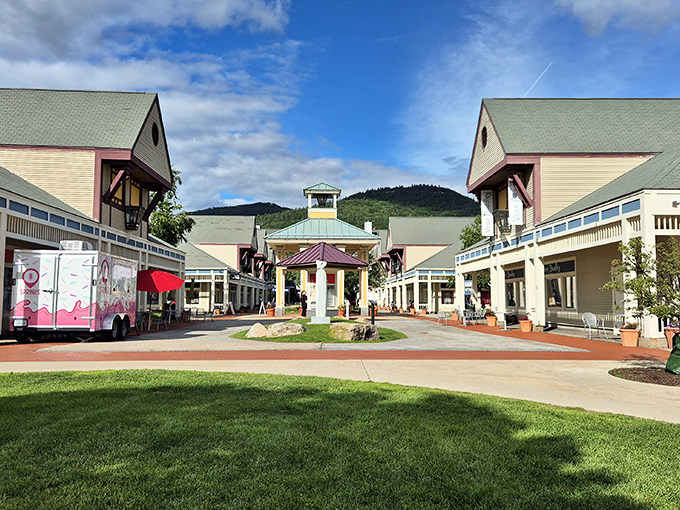 The grand entrance to Settlers Green beckons shoppers with its charming New England architecture and mountain backdrop. Shopping paradise found!