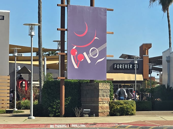 Colorful banners and palm trees guide bargain hunters to Forever 21 and other popular fashion destinations.