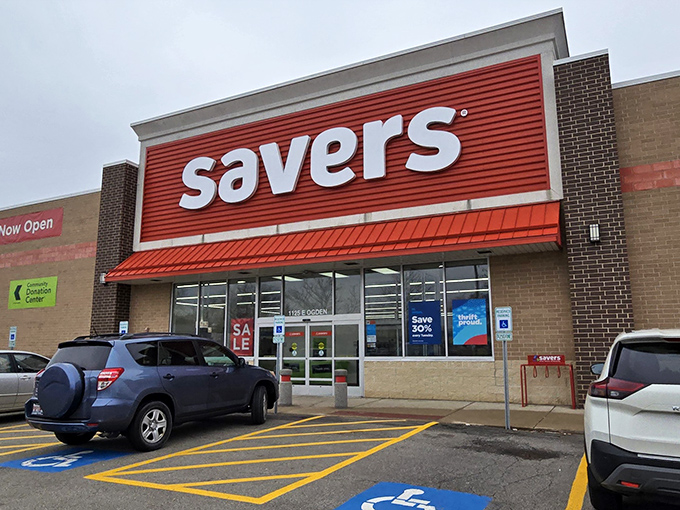The bright red Savers sign beckons like a lighthouse for bargain hunters. Your wallet's happy place awaits inside these unassuming brick walls.