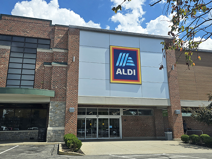 The iconic blue and yellow ALDI sign stands proudly against a bright sky, like a beacon of savings calling to budget-conscious shoppers across Louisville.