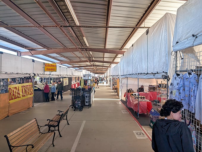 The covered walkways of Arizona Market Place stretch like a treasure map waiting to be explored, with numbered aisles guiding bargain hunters through their quest.