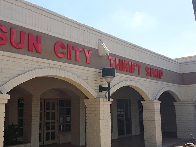 The iconic red lettering of Sun City Thrift Shop stands out against the white building like a beacon calling all bargain hunters to their happy place.