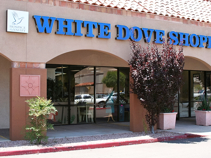 The White Dove Thrift Shoppe welcomes bargain hunters with its distinctive blue signage and Spanish-style roof&mdash;thrifting paradise awaits!
