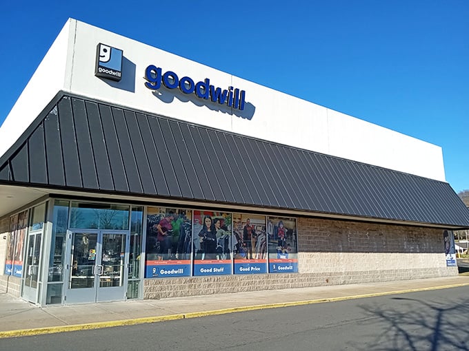 The blue Goodwill sign beckons like a lighthouse for bargain hunters. This modern exterior hides a wonderland of second chances and first-rate finds.
