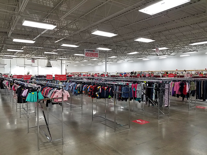 Treasure hunting paradise! Rows upon rows of neatly organized clothing racks stretch toward the horizon, promising fashion finds for every Iowan season.