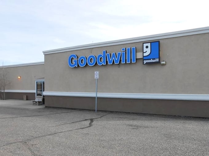 The blue Goodwill sign beckons like a retail oasis in the Wyoming landscape, promising treasures that won't require a second mortgage to acquire.