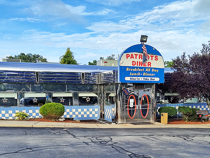 The iconic blue and white checkered exterior of Patriots Diner stands like a time machine to the golden age of American breakfast. That retro sign promises everything your morning needs.