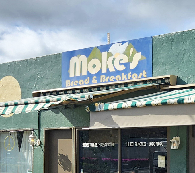 The turquoise facade of Moke's Bread & Breakfast stands like a beacon of breakfast hope on Kailua's quiet streets. Paradise awaits inside.