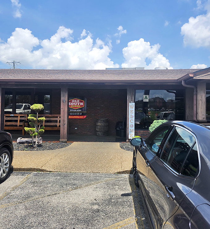 The unassuming entrance to Ole South Barbeque promises no frills, just thrills for your taste buds. That wooden barrel isn't just for show&mdash;it's foreshadowing the smoky goodness awaiting inside.