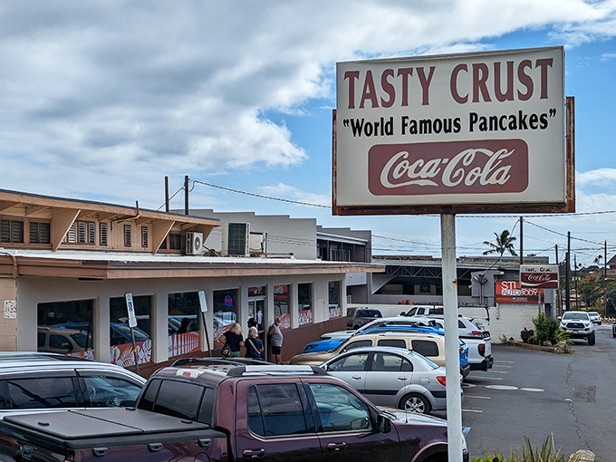 The simple sign of Tasty Crust might not catch your eye, but locals know it marks a spot where breakfast magic happens inside.